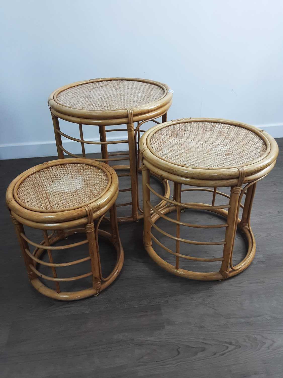 Lot 120 - CANE NEST OF THREE TABLES,
